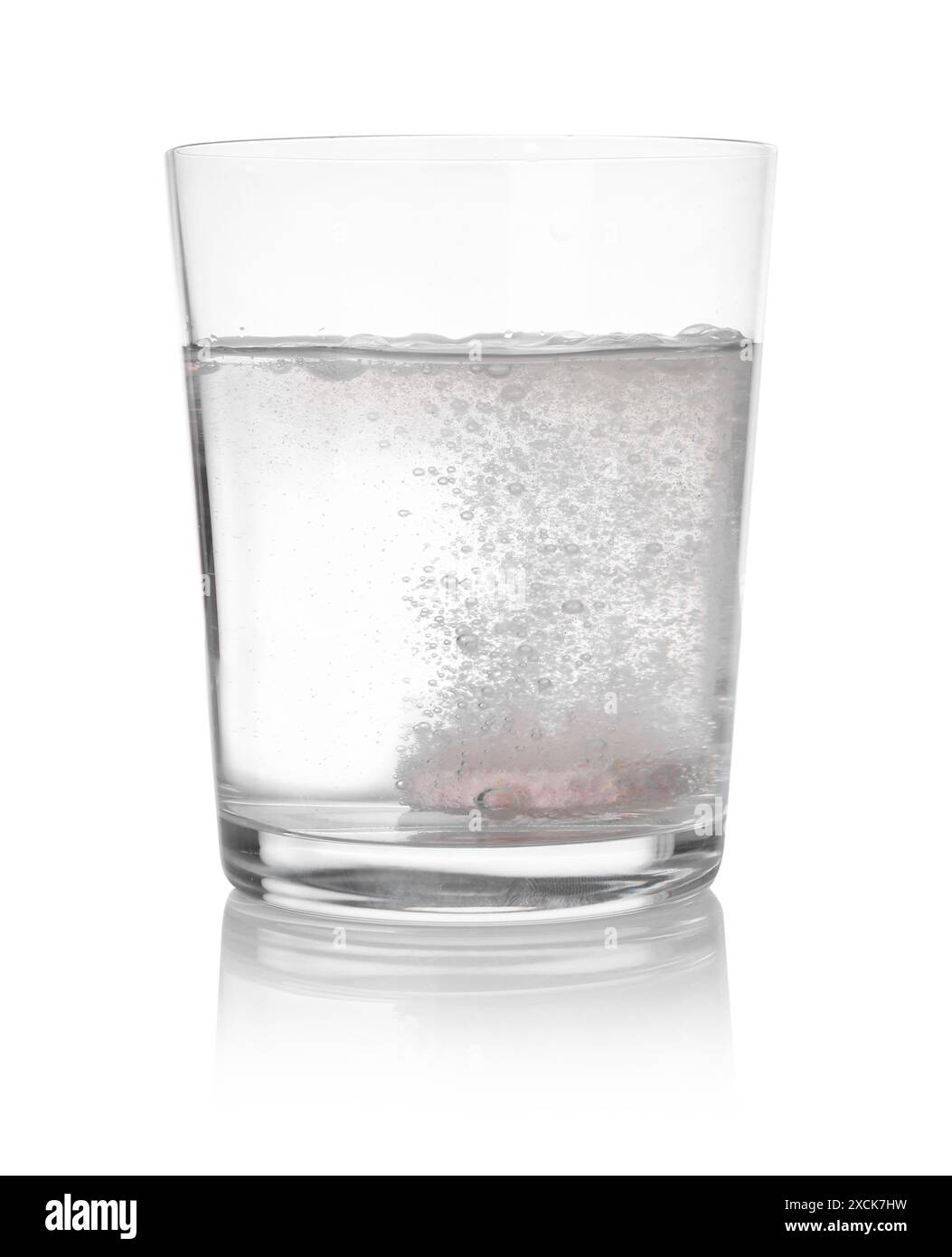 Effervescent pill dissolving in glass of water isolated on white Stock ...