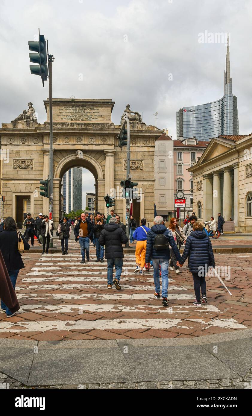 People crossing the road in front of the Porta Garibaldi ancient city ...