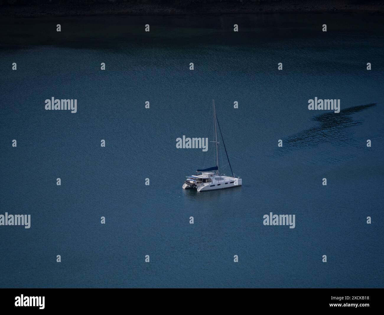 One lone white luxury yacht boat ship sitting in blue ocean water of ...