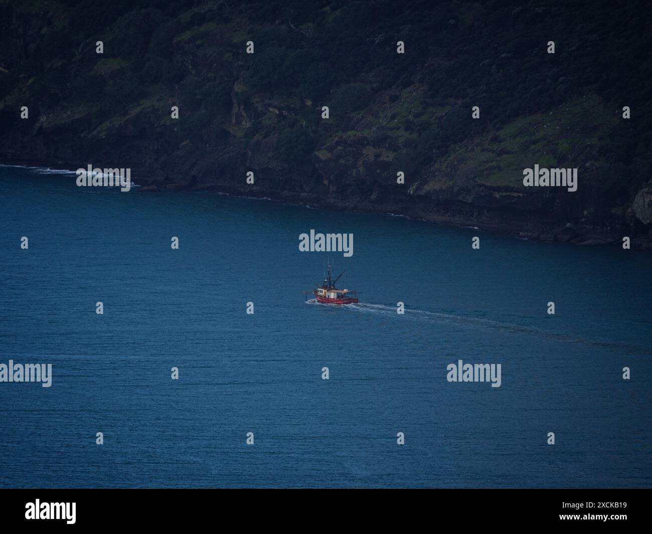 One lone fishing trawler boat ship cruising in blue ocean water of ...
