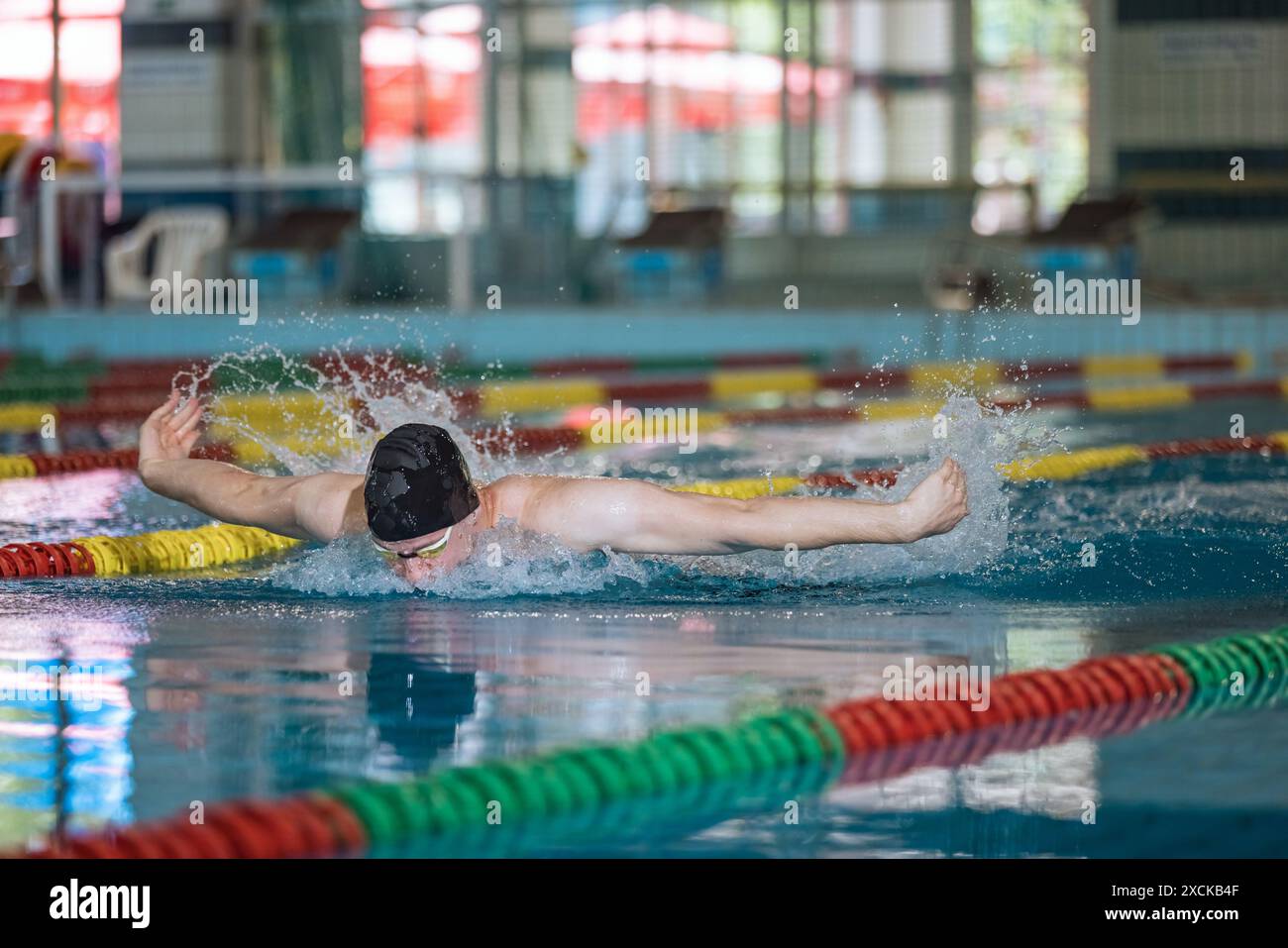Male professional athlete swimming in butterfly style, with both arms ...