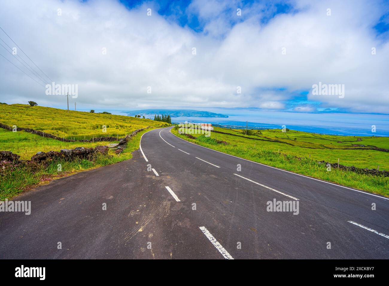 Tarmac road with the beautiful landscape surrounding the island of Pico ...