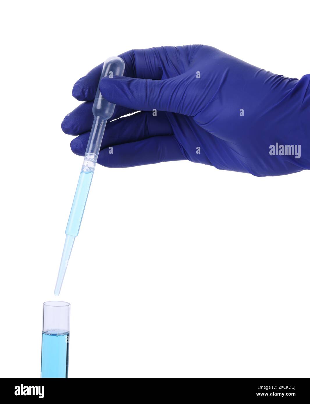Scientist dripping liquid from pipette into test tube on white ...