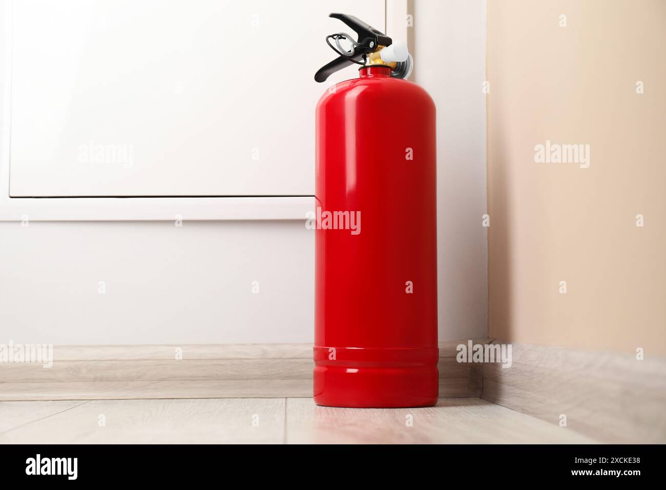 Fire extinguisher on floor indoors. Safety equipment Stock Photo - Alamy