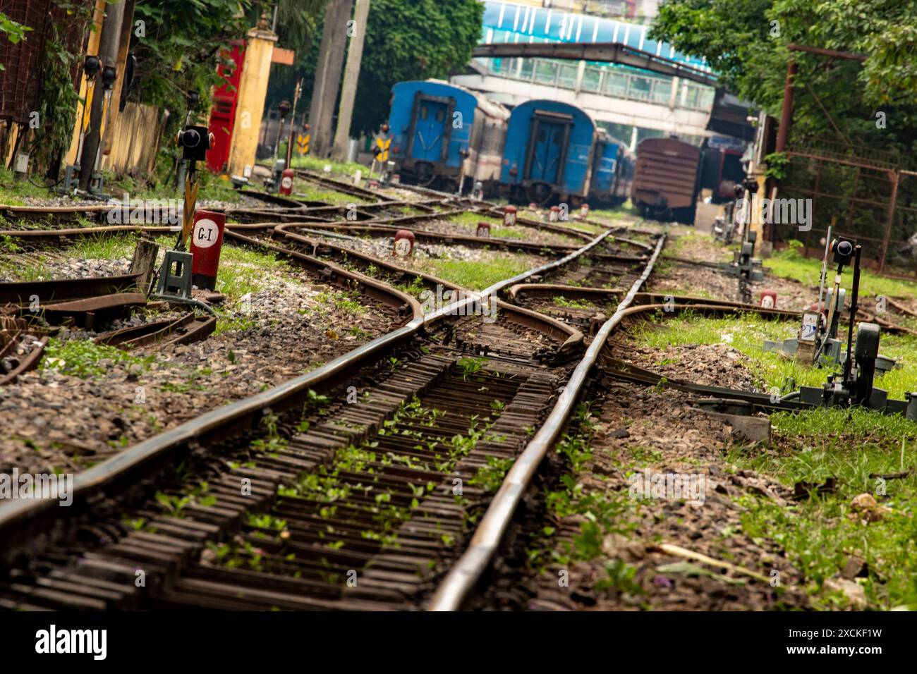 Rail track and blue Hanoi (Vietnam) 'Doorway Railway' train at rest ...