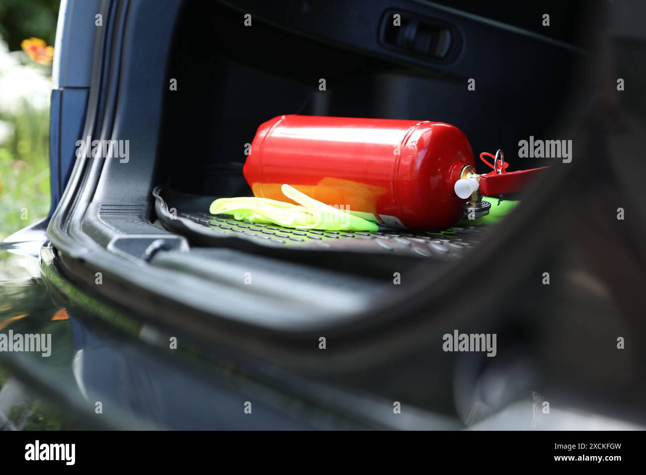 Red fire extinguisher in trunk. Car safety equipment Stock Photo - Alamy