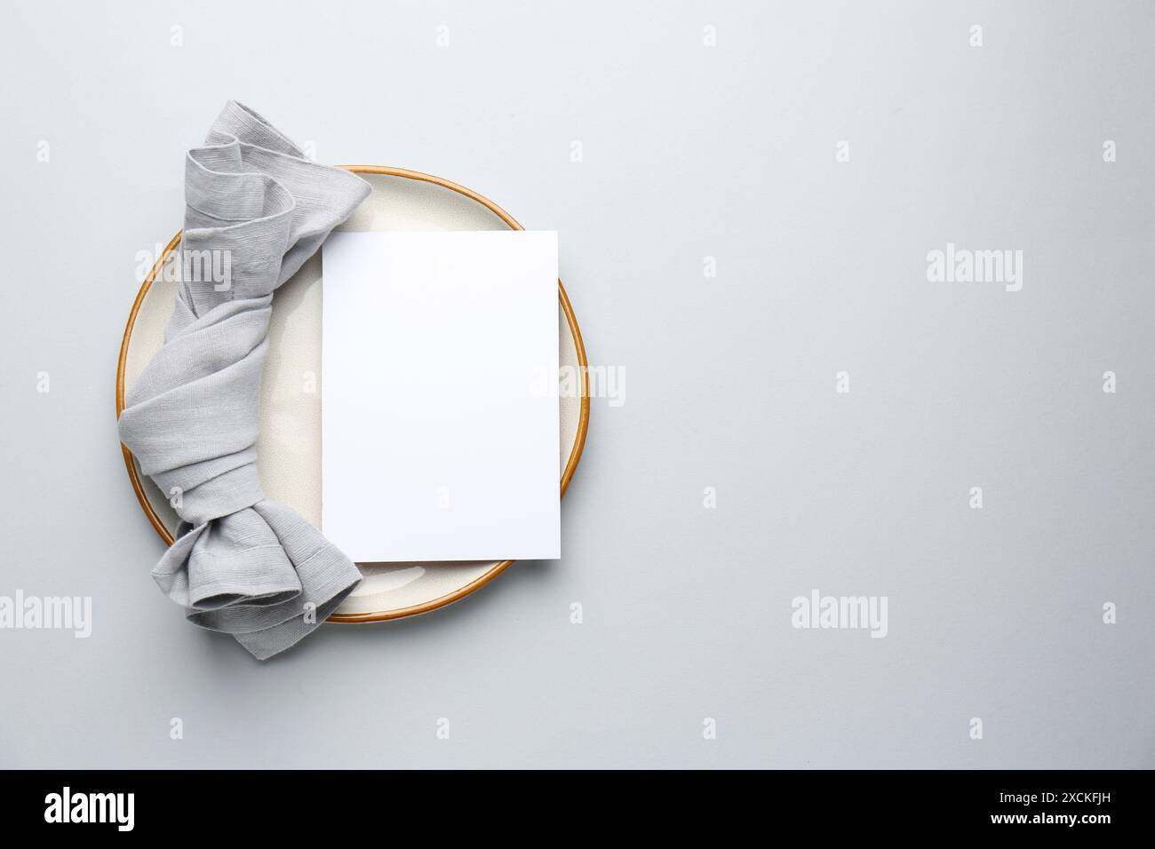 Empty menu, plate and napkin on light grey background, top view. Mockup ...
