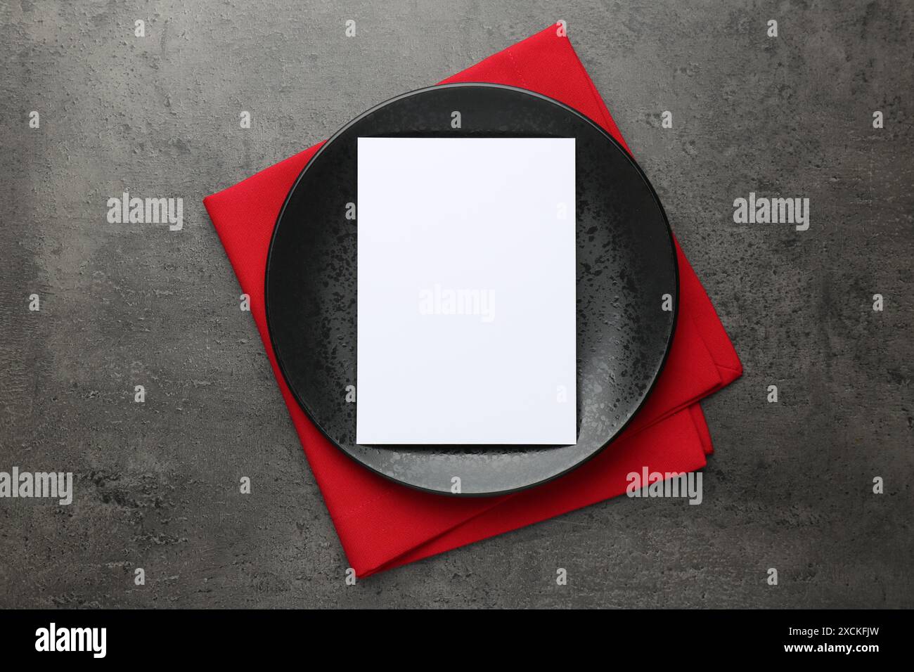 Empty menu, plate and napkin on grey table, top view. Mockup for design ...