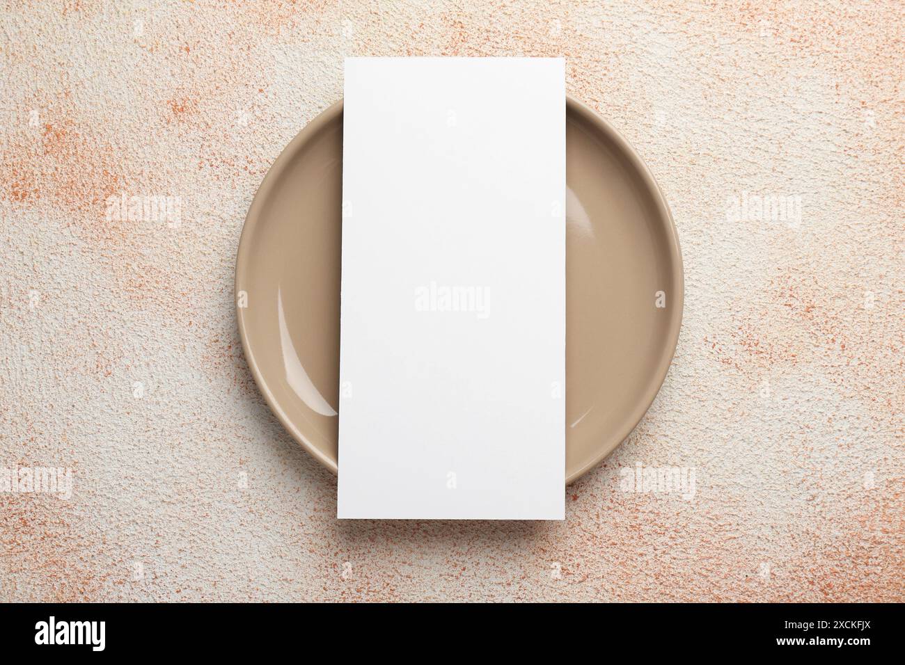 Empty menu and plate on color textured table, top view. Mockup for ...