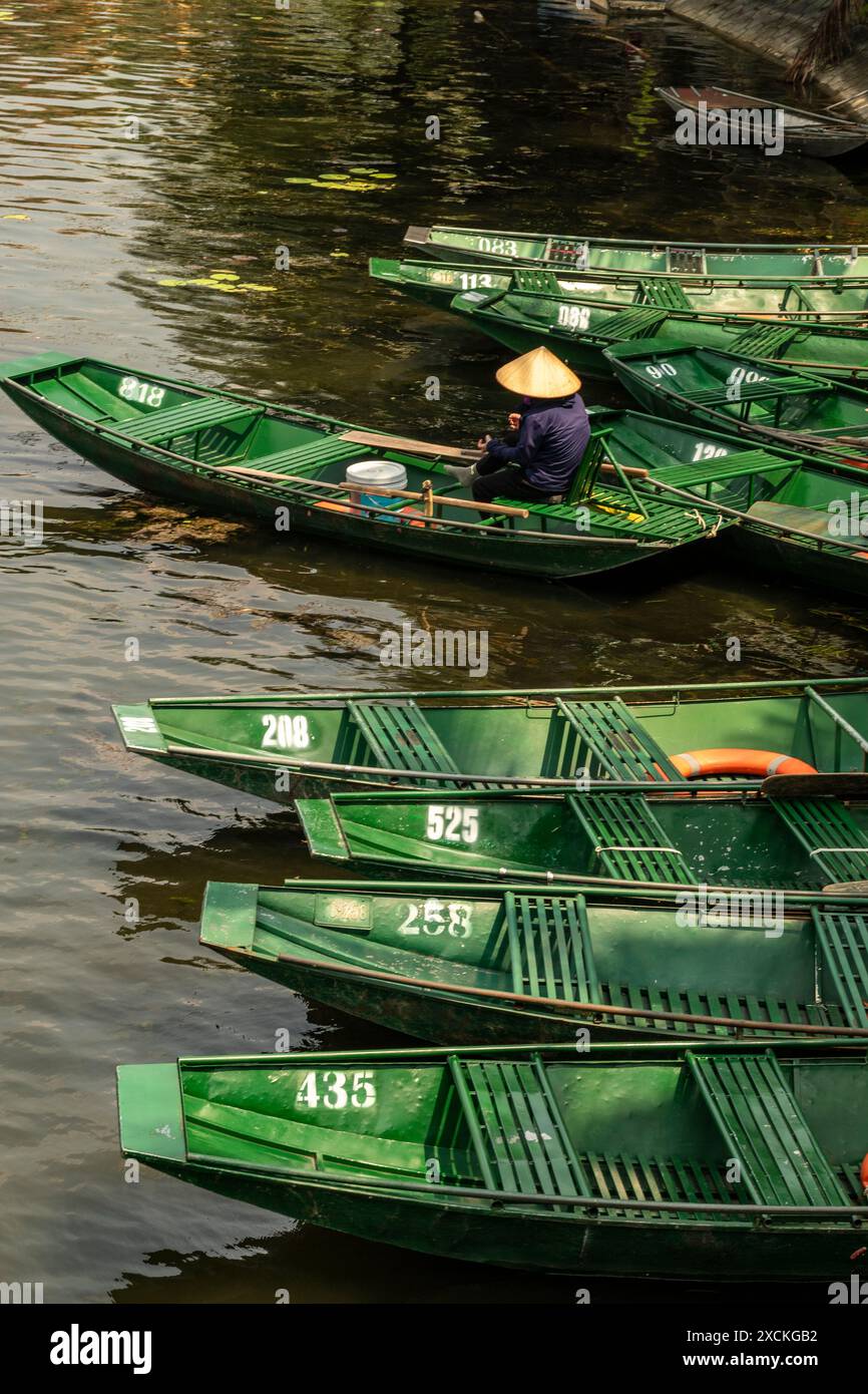 Tourist Sampans lined up along the marvellously tranquilTam Coc river ...