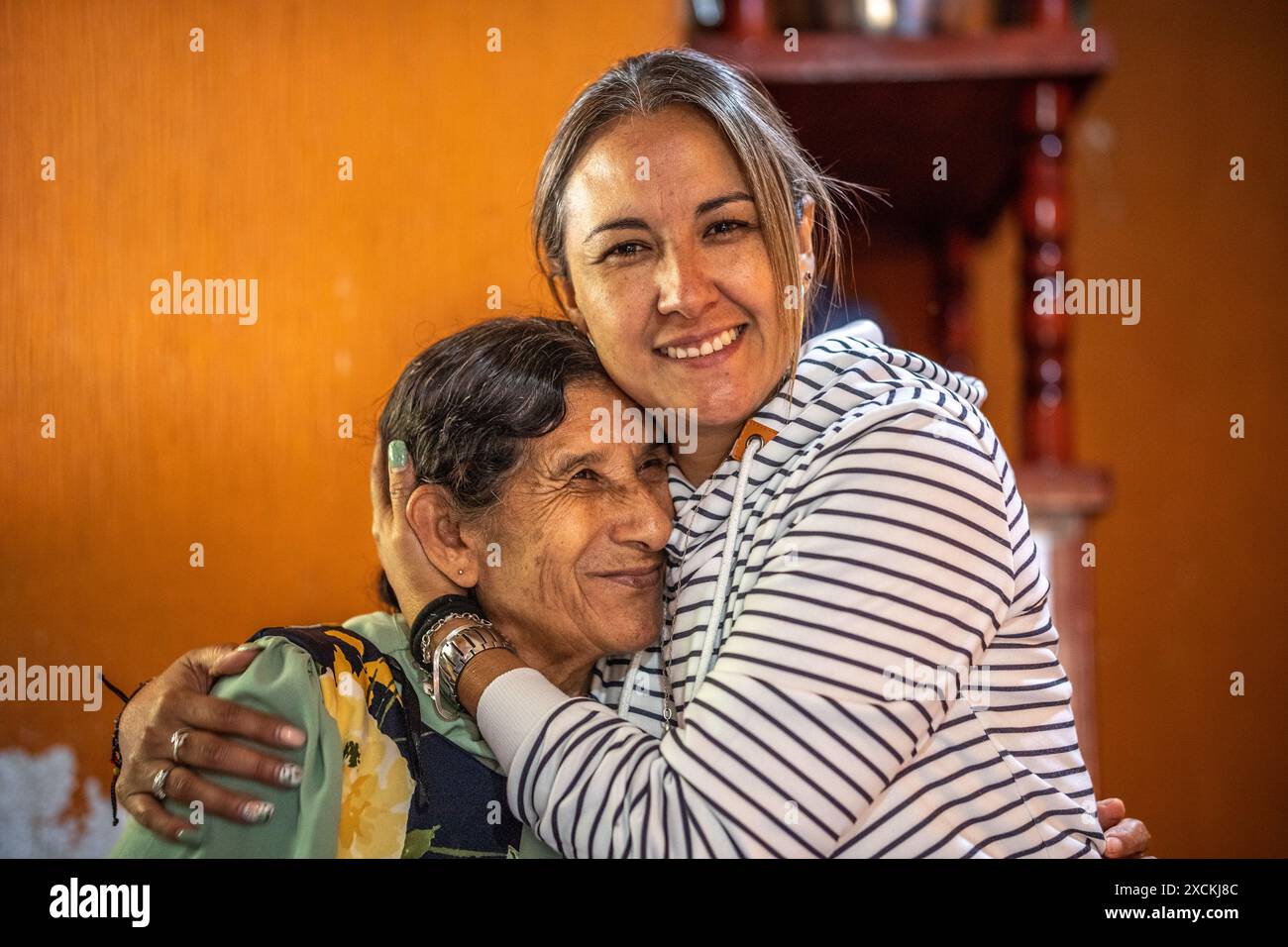 Woman hugging family matriarch Guatemala Stock Photo - Alamy
