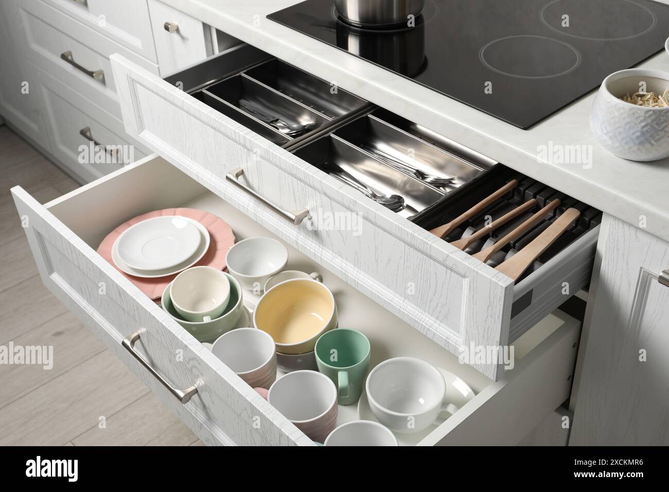 Ceramic dishware, utensils and cutlery in drawers in kitchen Stock ...