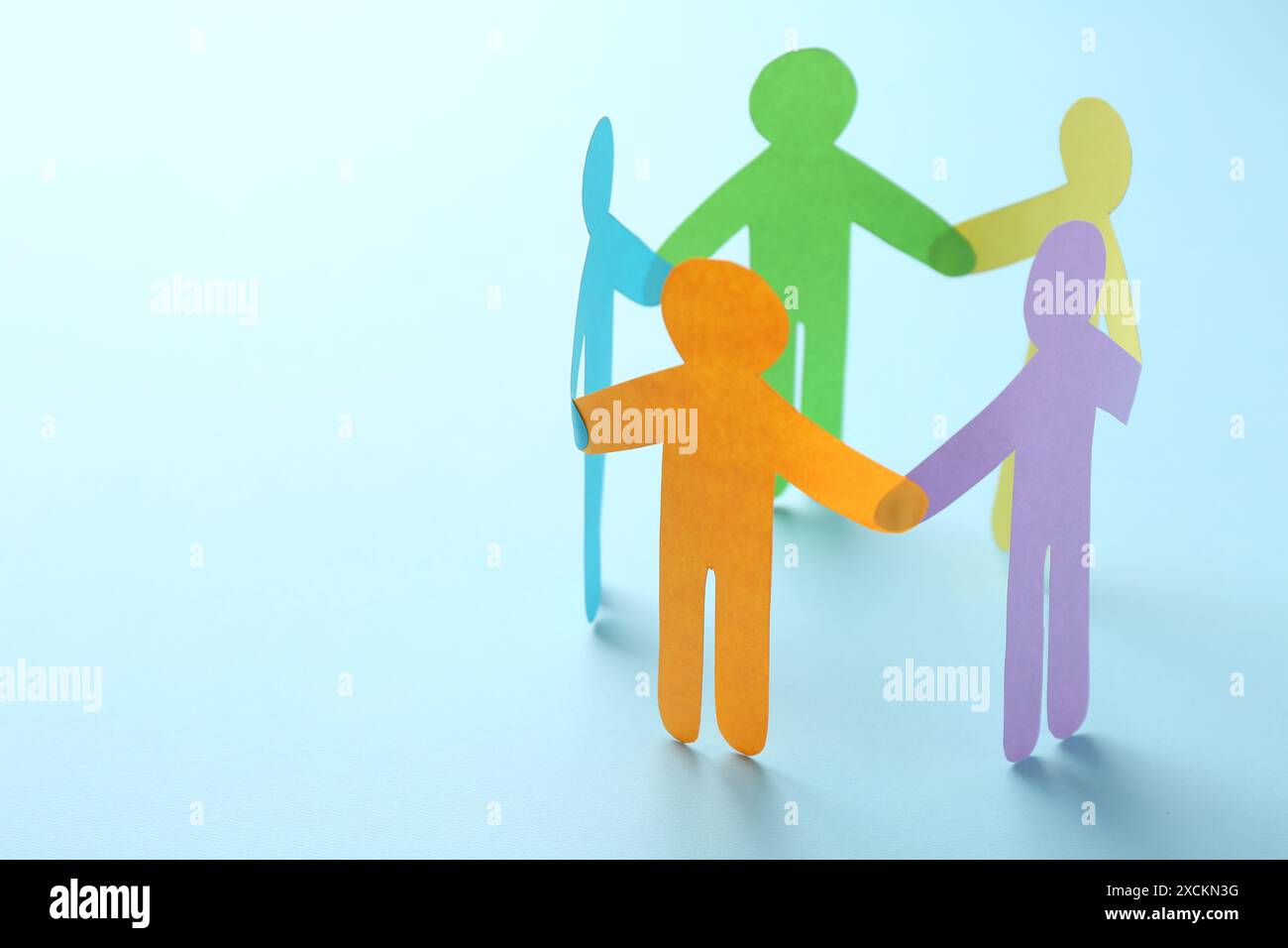 Equality concept. Paper human figures on light blue background, closeup ...