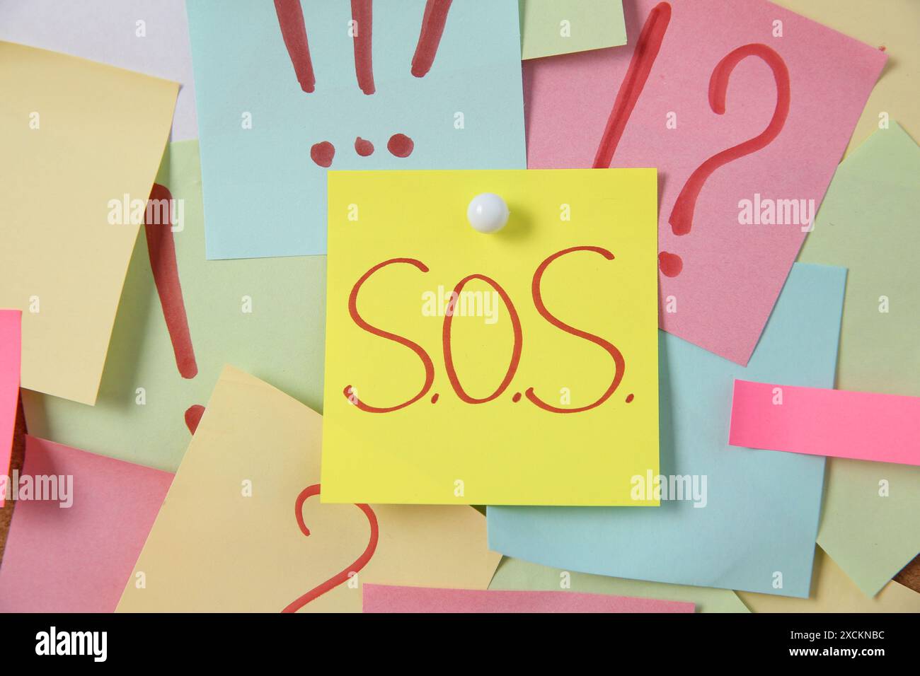Notes with word SOS and symbols on board, closeup Stock Photo - Alamy