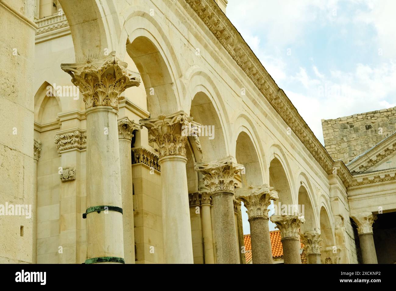 The arches of a building are white and the pillars are made of stone ...