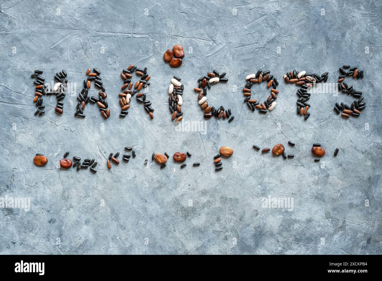 French word HARICOTS (meaning Beans) is laid out on a grey background ...