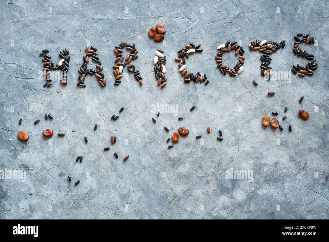 French word HARICOTS (meaning Beans) is laid out on a grey background ...