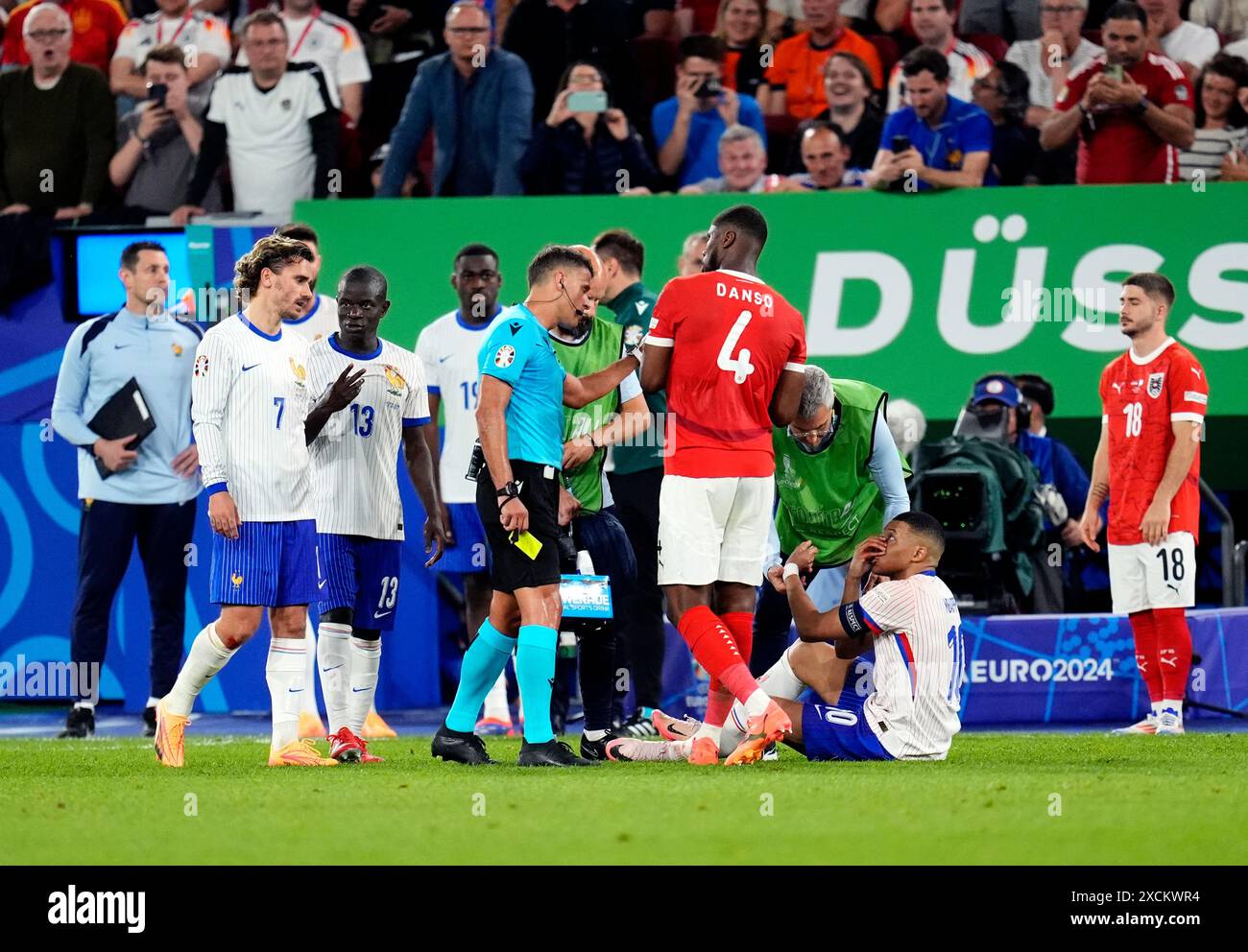 France's Kylian Mbappe (floor) is shown a yellow card by referee Jesus ...