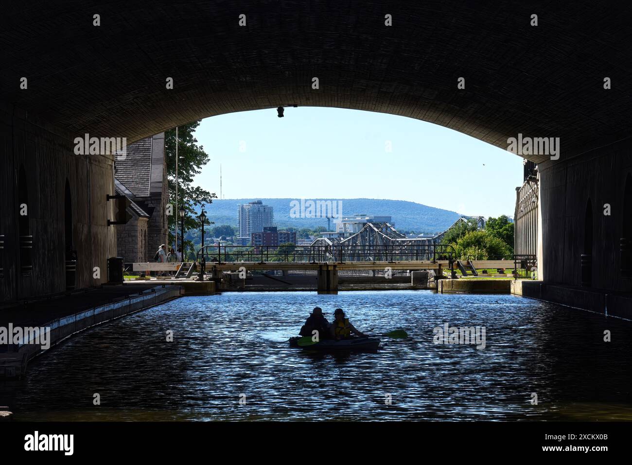 A couple canoes under a bridge on the Rideau Canal. The canal locks and ...