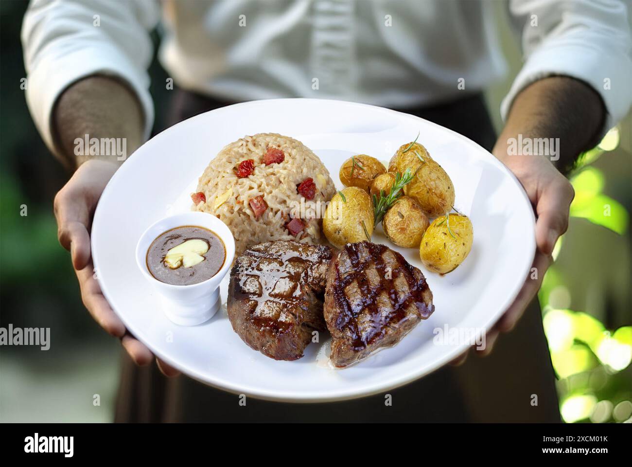 Roasted steak meat, potatoes and rice Stock Photo - Alamy