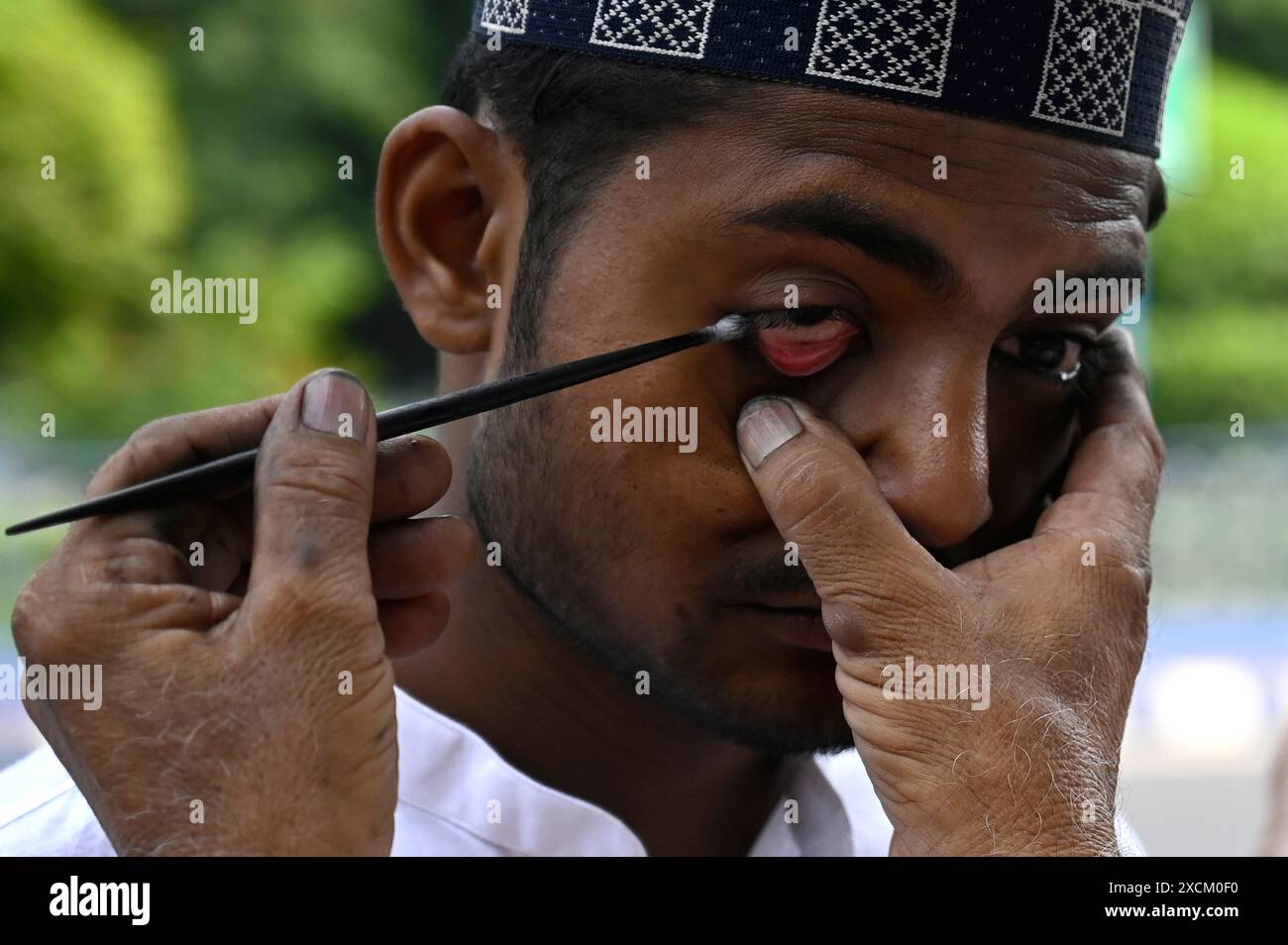KOLKATA, INDIA - JUNE 17: A muslim devotee applying 'surma' before the ...