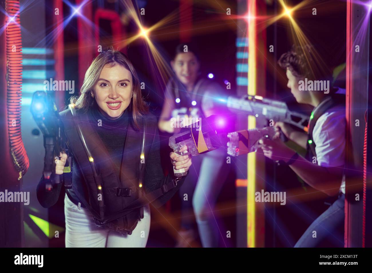 Girl running and dodging while playing lasertag Stock Photo - Alamy