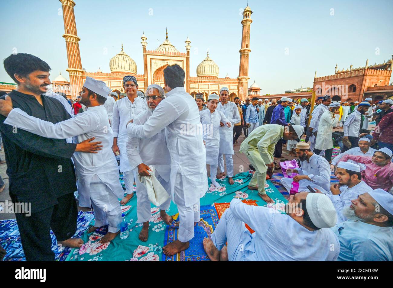 NEW DELHI, INDIA - JUNE 17: Muslims embrace after offering Eid al-Fitr ...