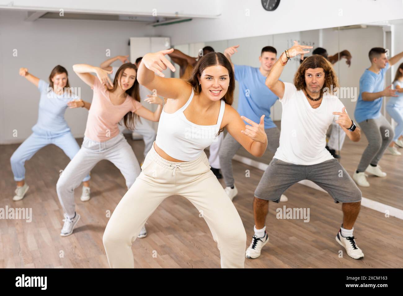 Group of different people rehearsing dance in dance studio Stock Photo ...