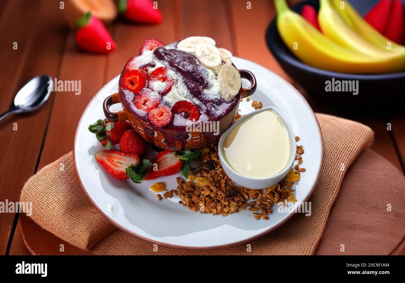 Acai cream with granola, strawberry, banana, condensed milk Stock Photo ...