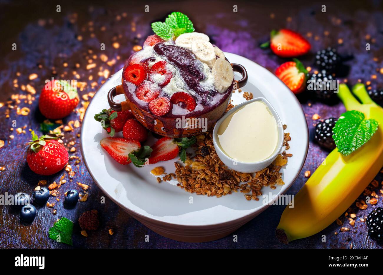 Acai cream with granola, strawberry, banana, condensed milk Stock Photo ...