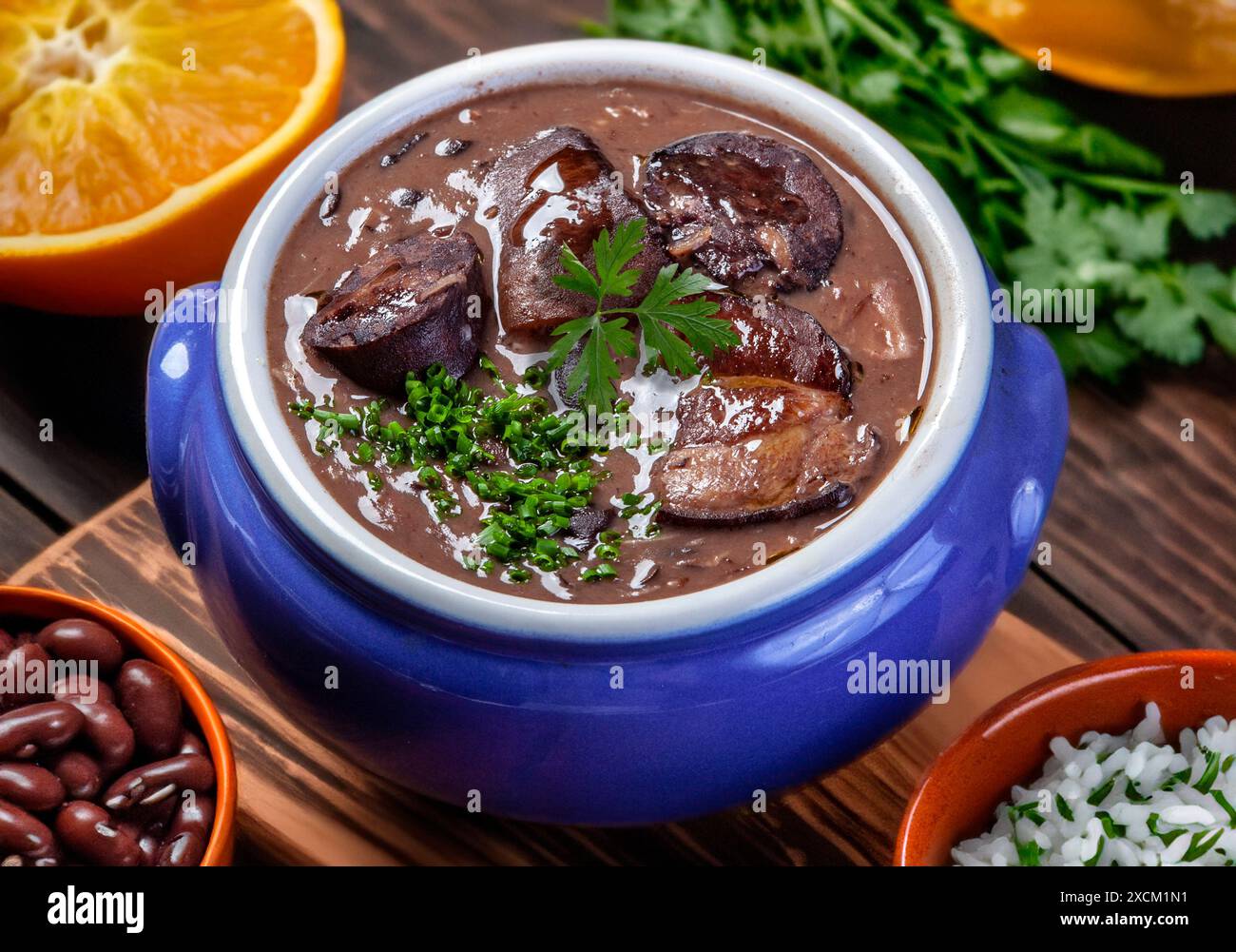 Feijoada traditional Brazilian food served with rice, farofa, orange ...
