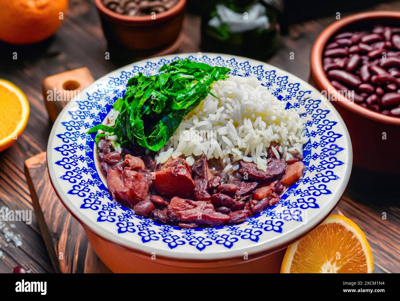 Feijoada traditional Brazilian food served with rice, farofa, orange ...