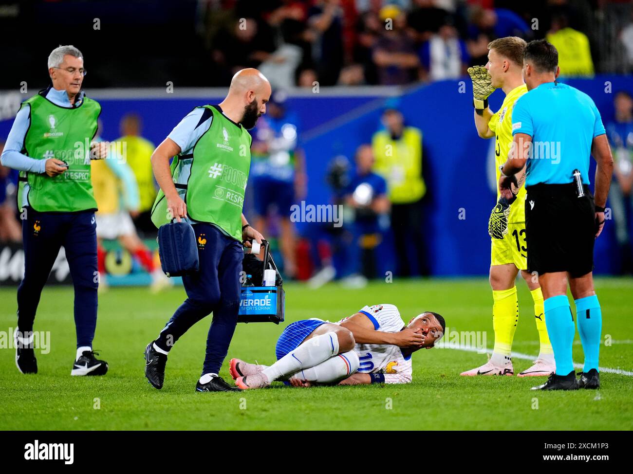 France's Kylian Mbappe lies injured on the pitch after colliding with ...