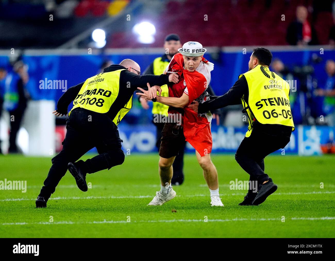 Stewards stop a pitch invader at the end of the UEFA Euro 2024 Group D match at the Dusseldorf ...