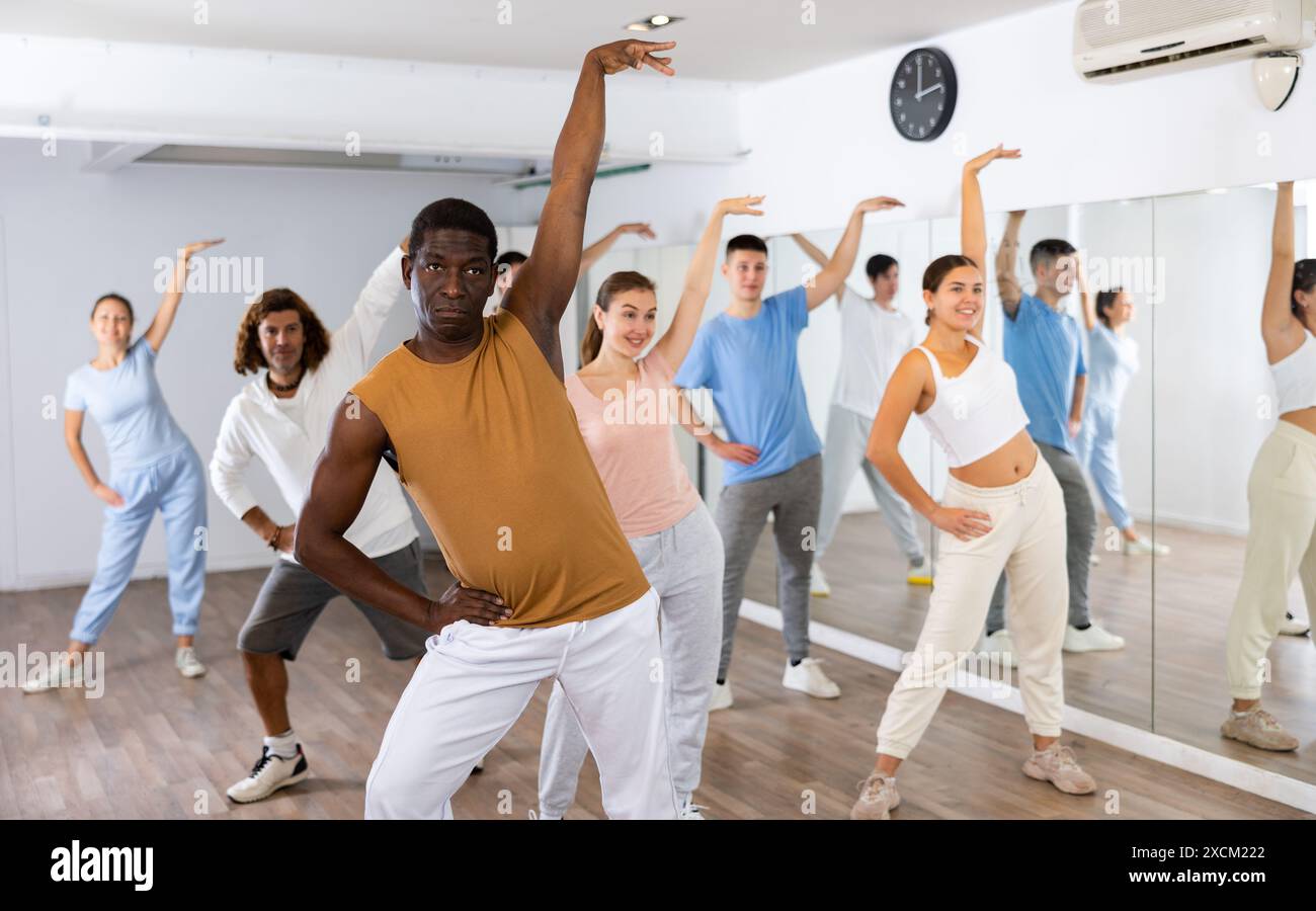 Group of different people rehearsing dance in dance studio Stock Photo ...