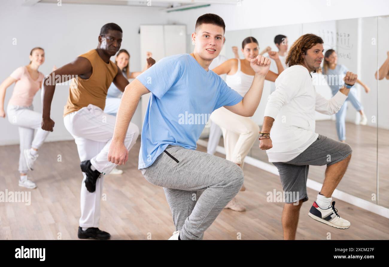 Group of cheerful young adult diverse dancers performing dynamic ...