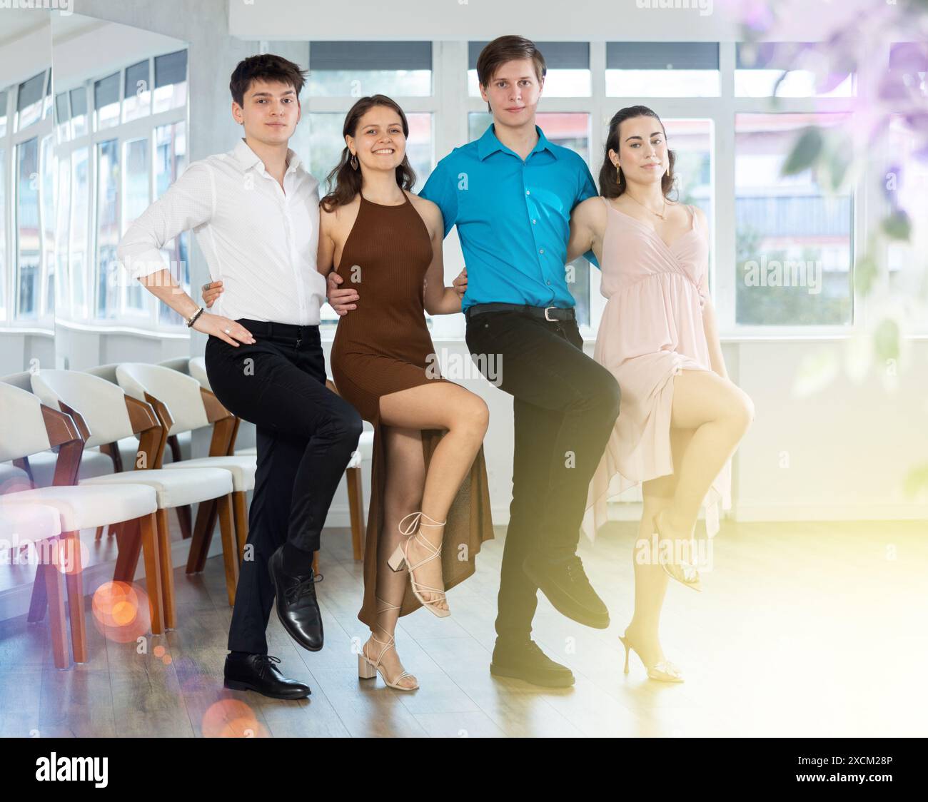 Girls and guy dancing folk dance in row in dance studio Stock Photo - Alamy