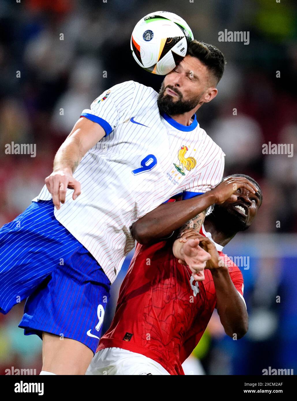 France's Olivier Giroud (left) and Austria's Kevin Danso battle for the ...