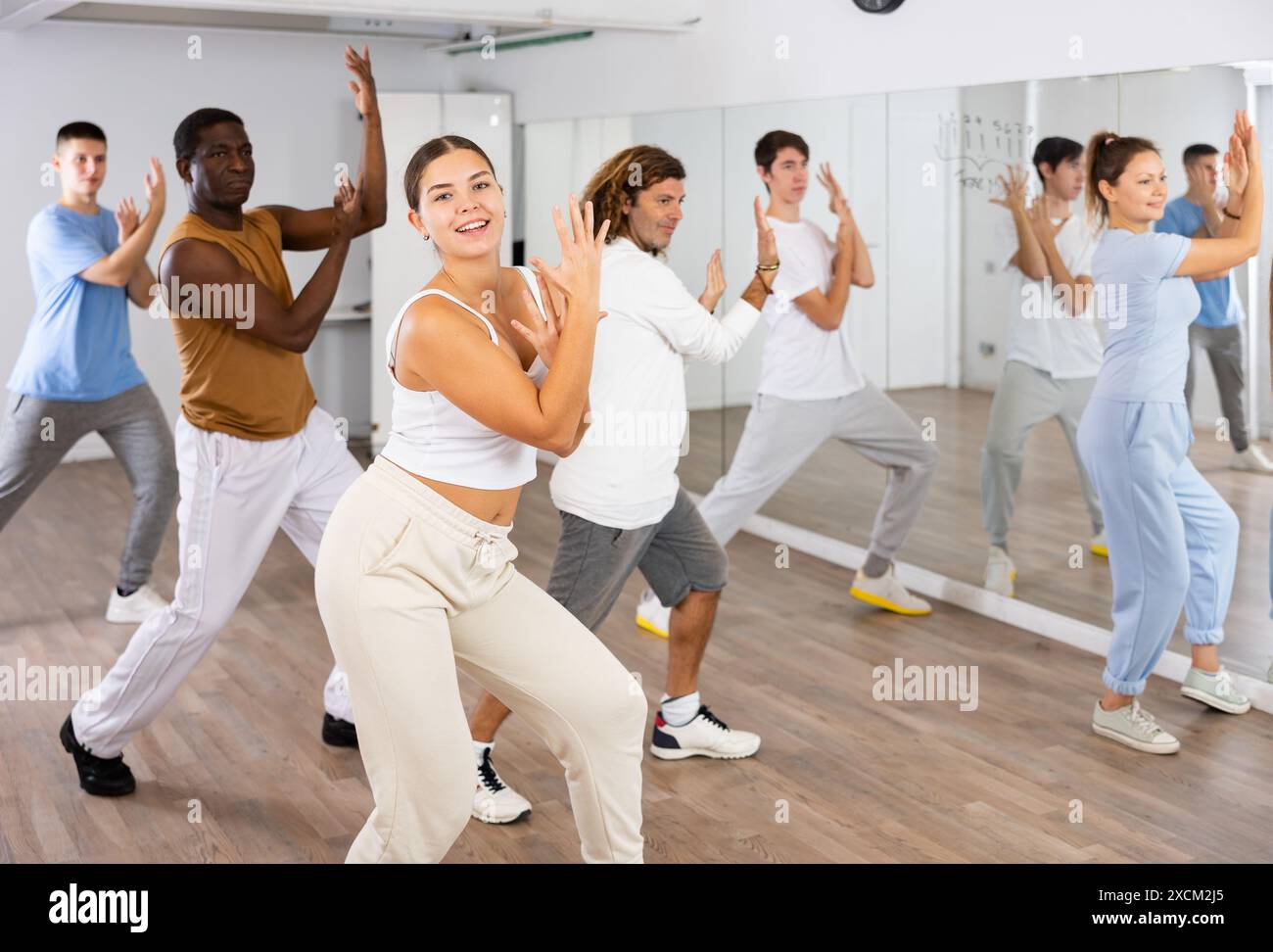 Group of international people dancing in gym with crossed hands. The ...