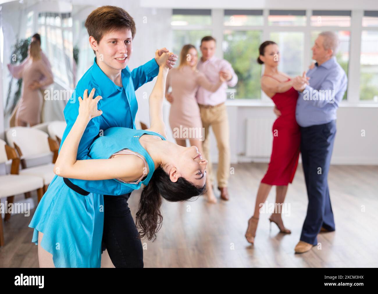 Teaching latin american dances in dance studio - people of different ...