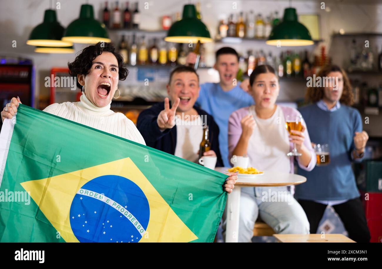 Emotional friends, football fans cheering for favorite Brazil team ...