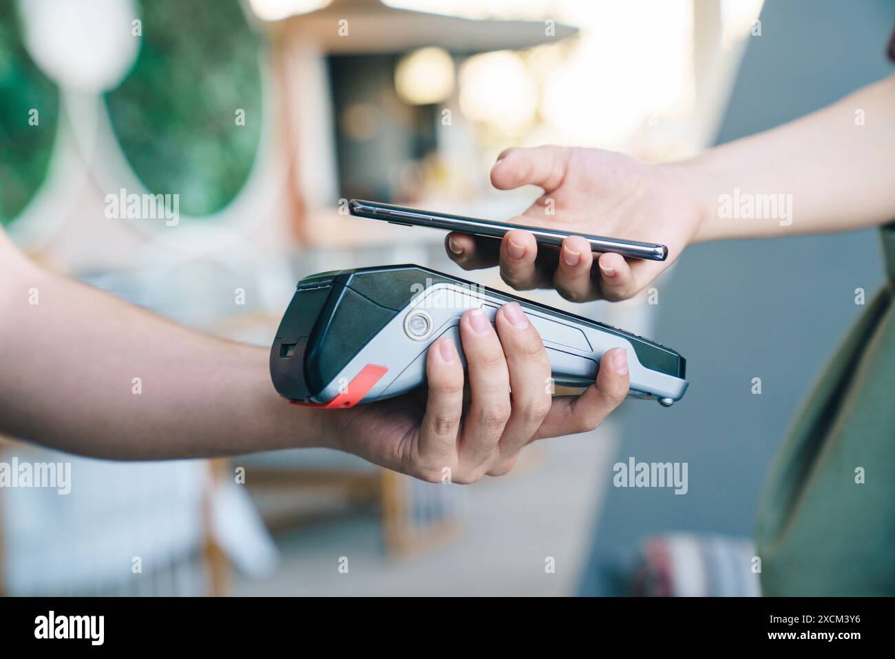 Woman paying bill through hi-res stock photography and images - Alamy