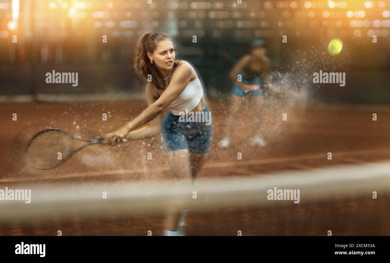 Stylized shot of young female tennis player swinging racket to hit ball ...