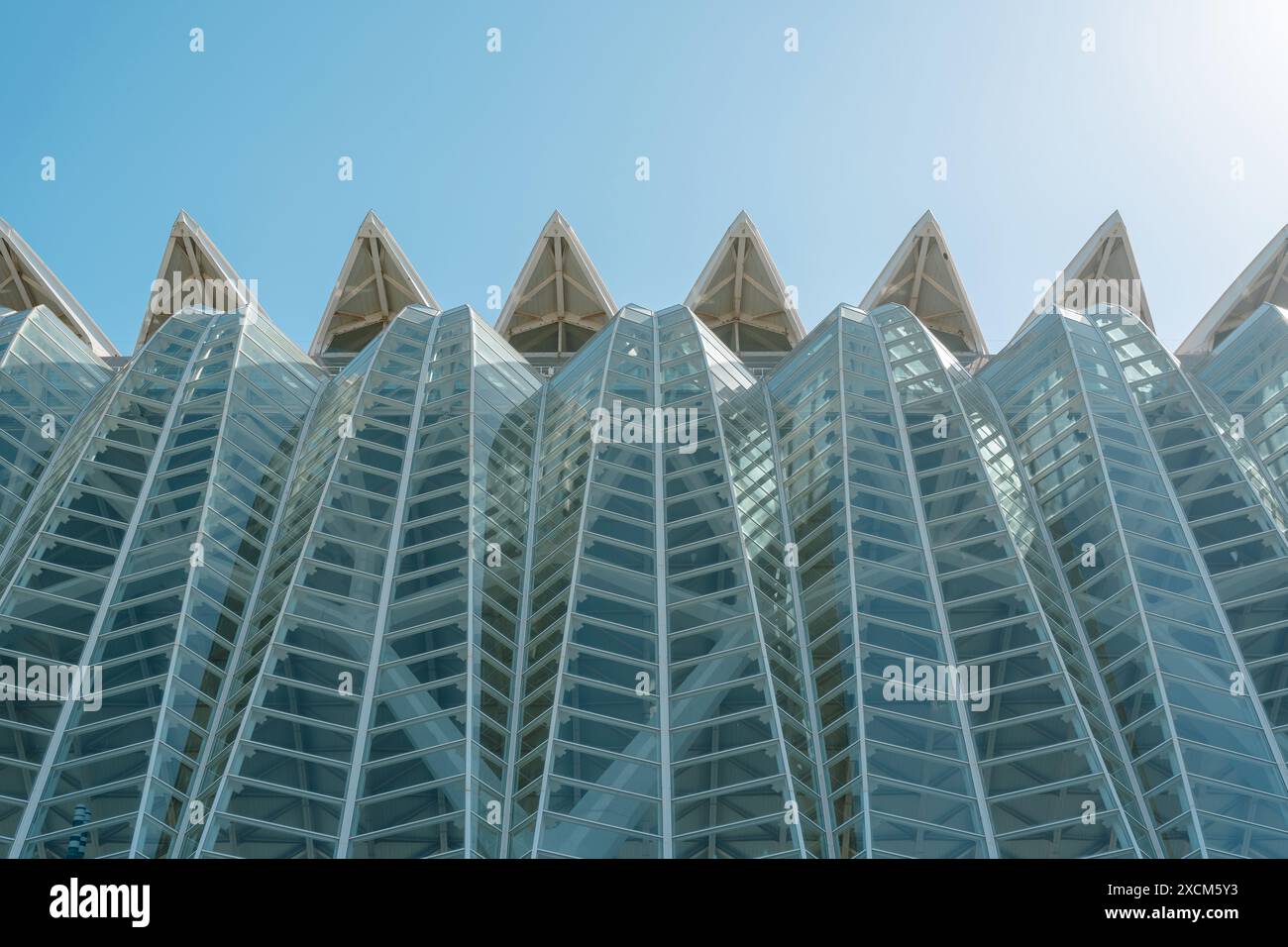 Futuristic glass building exhibiting a bold angular design. The ...