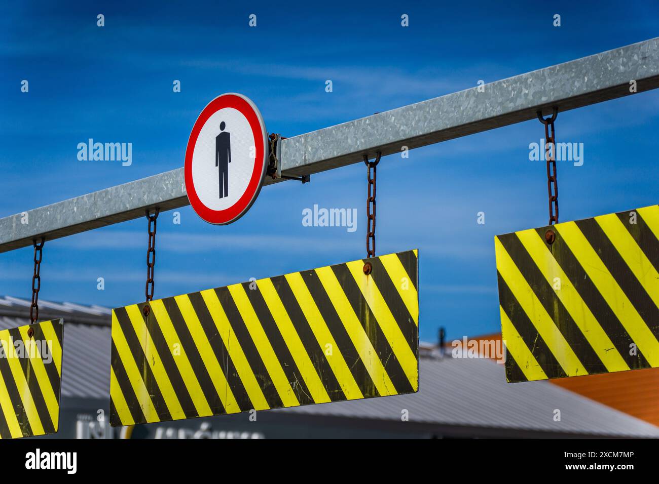 Red And Yellow Road Signs Hanging From Chains On A Bar Stock Photo - Alamy