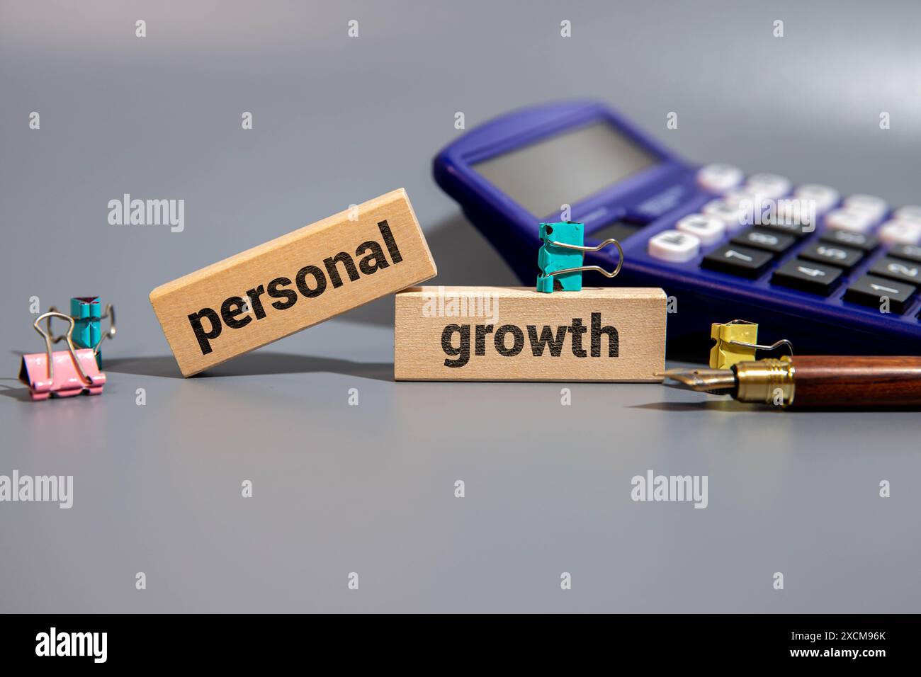 PERSONAL GROWTH text on paper clipboard with chart and notebook on a ...