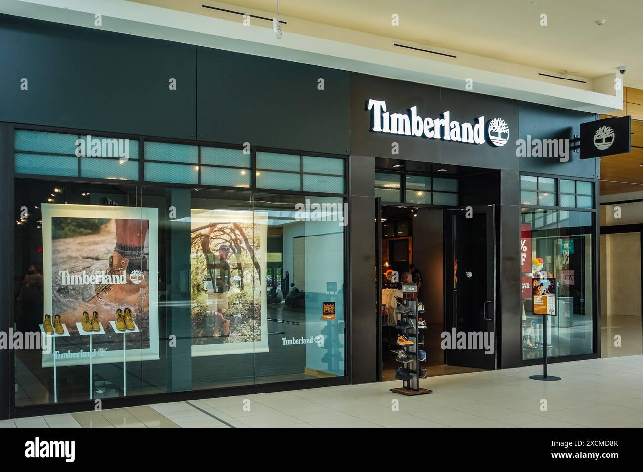 Front entrance of a Timberland retail store featuring a sleek black ...