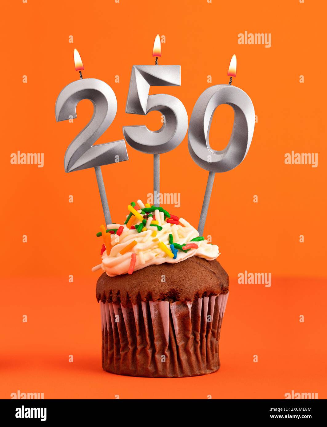 Birthday cupcake with number 250 candle - Orange color background Stock ...