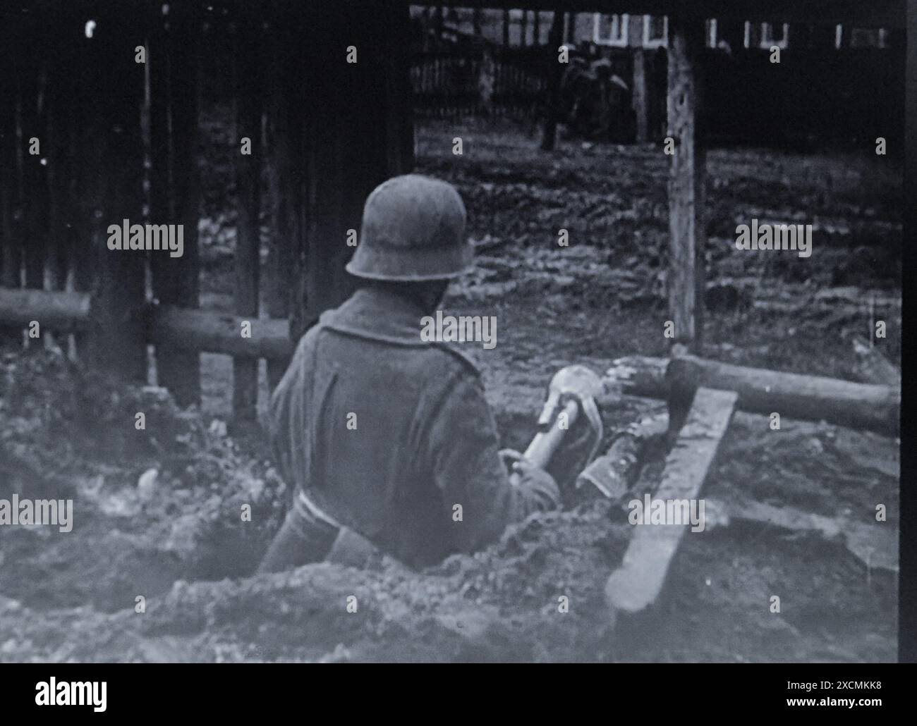 World War Two B&W Screenshot photo . German Soldier behind a fence with ...