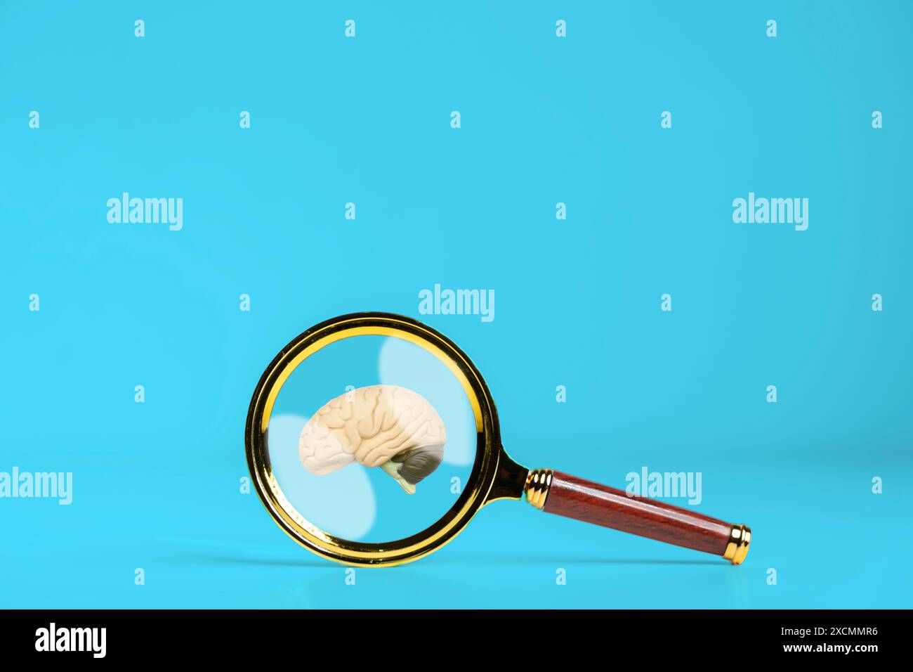 Magnifying glass and human brain on blue background, mental health care ...